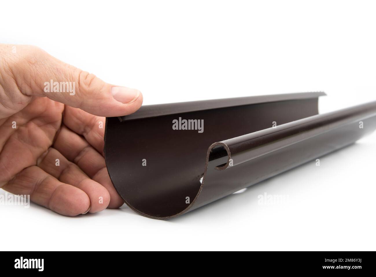 Brown plastic guttering on a white Stock Photo - Alamy