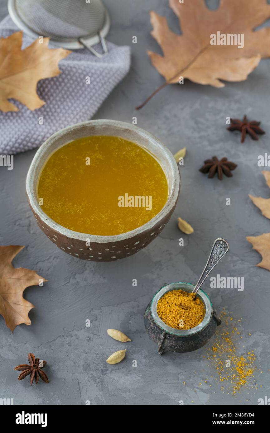 Healthy homemade Ghee or clarified butter in a jar and turmeric powder ...