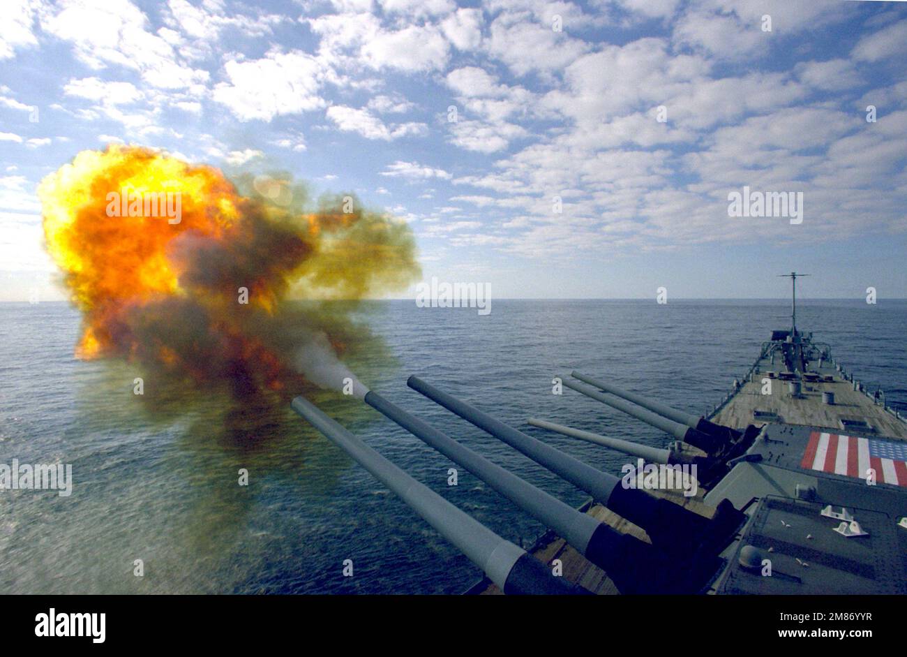 The battleship USS IOWA (BB-61) fires the center Mark 7 16-inch/50 ...