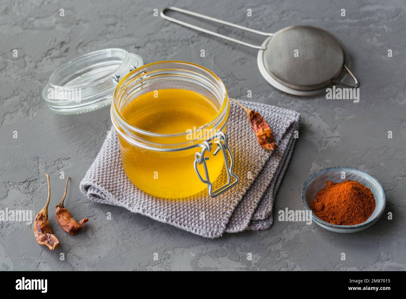 Homemade Ghee or clarified butter in a jar, chili and paprika powder on ...
