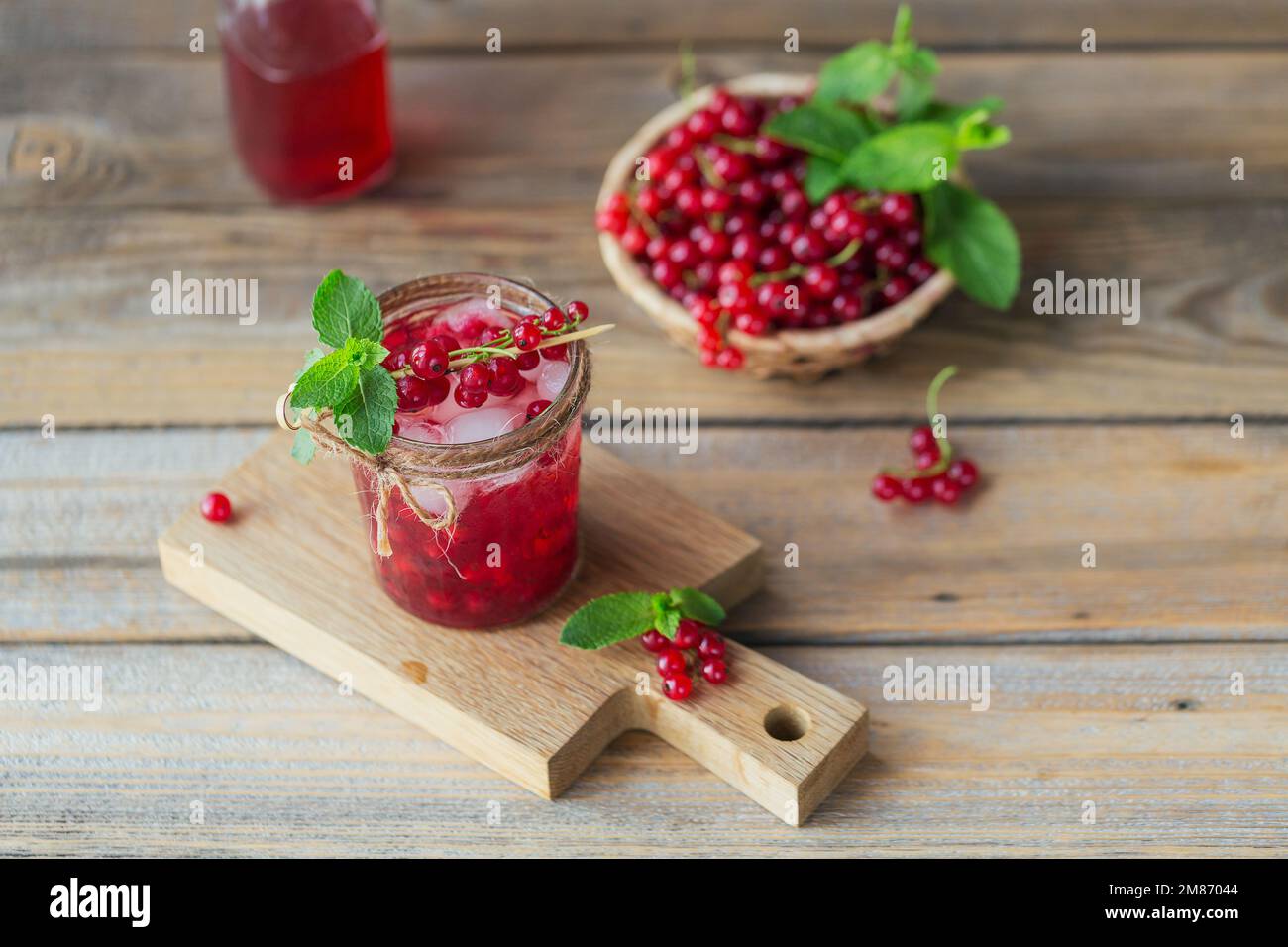 Glass of red currant cocktail or mocktail, refreshing summer drink with ...