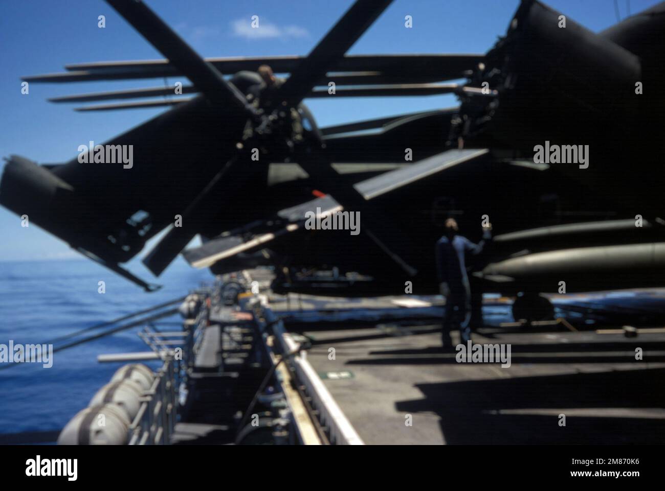 Navy personnel service the tail section of a CH-53E Super Stallion ...