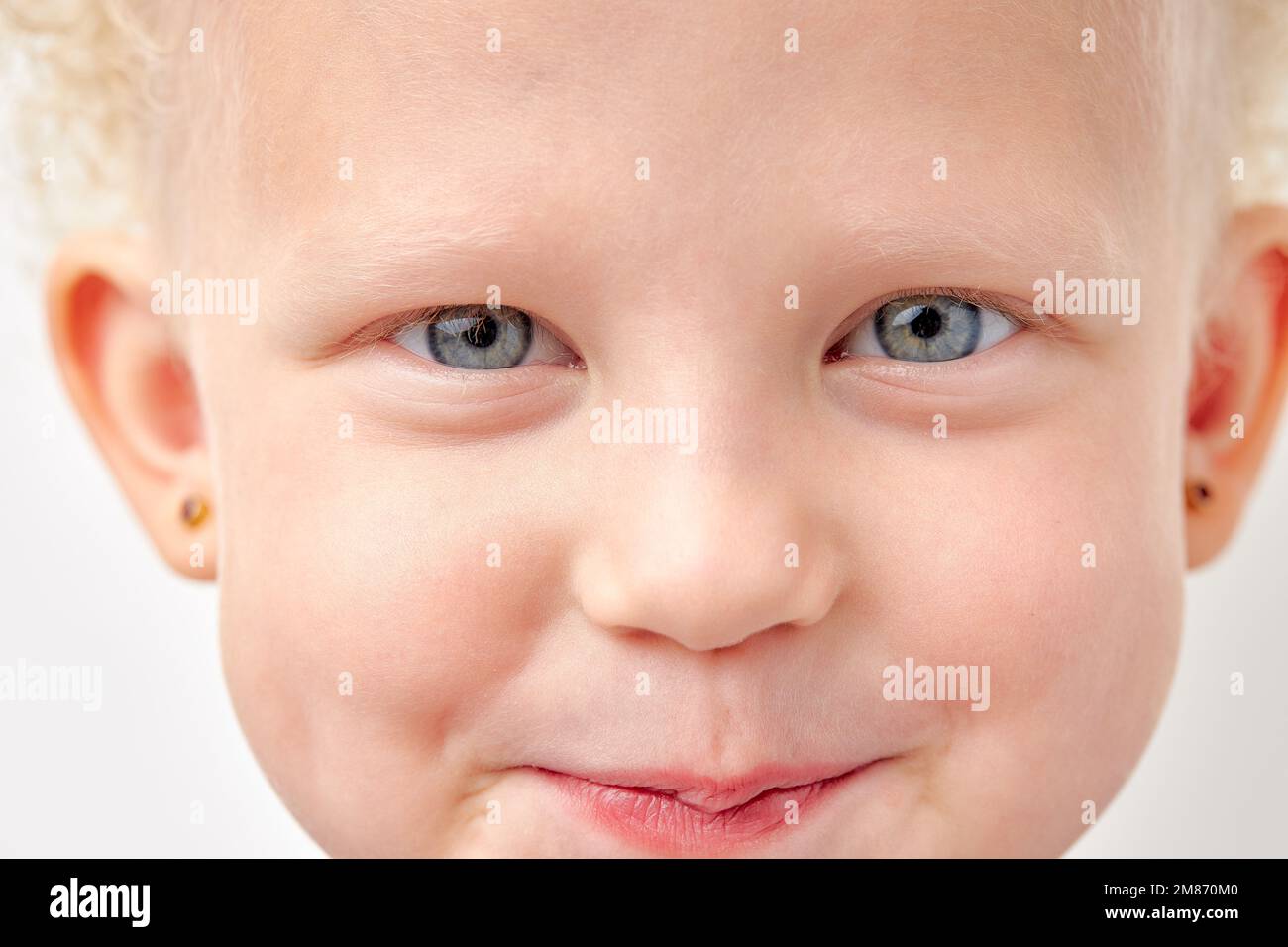close-up portrait of healthy caucasian child girl looking at camera ...