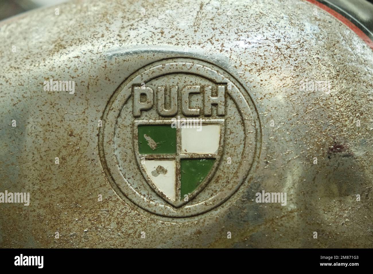 A rusty emblem of a Puch motorcycle symbol. closeup shot Stock Photo ...