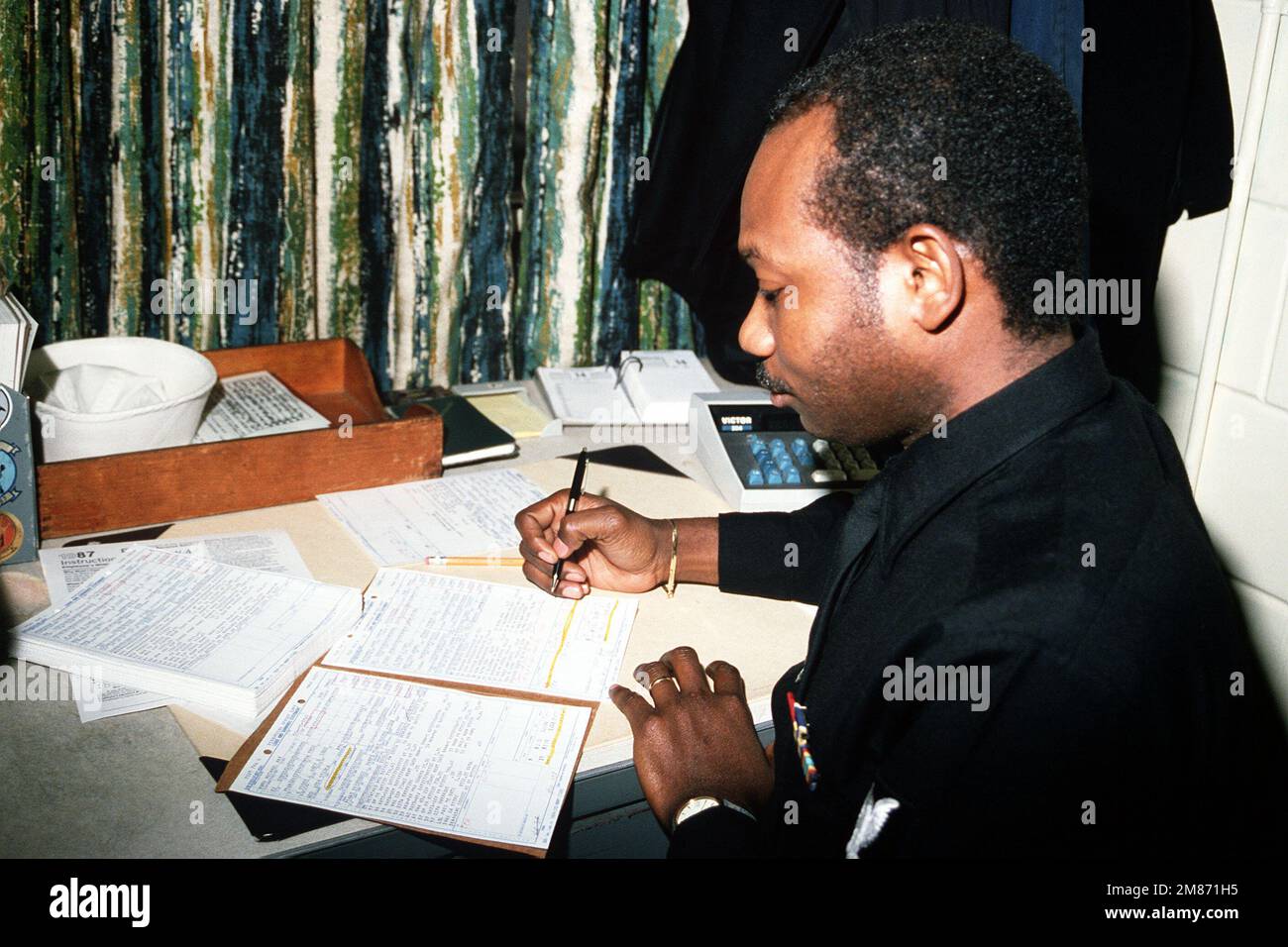 A disbursing clerk checks over a leave and earnings statement in the ...