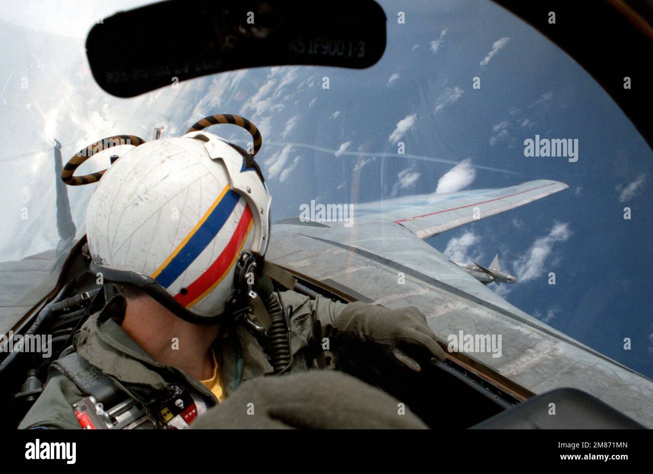 The radar intercept officer aboard a Fighter Squadron 2 (VF-2) F-14A Tomcat aircraft checks the ...