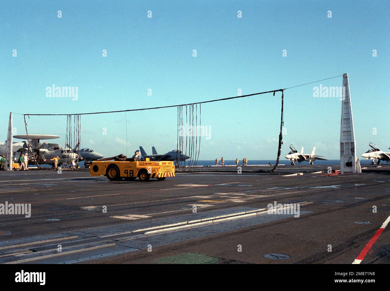 An MD-3A tow tractor is postioned in front of the crash barricade on ...
