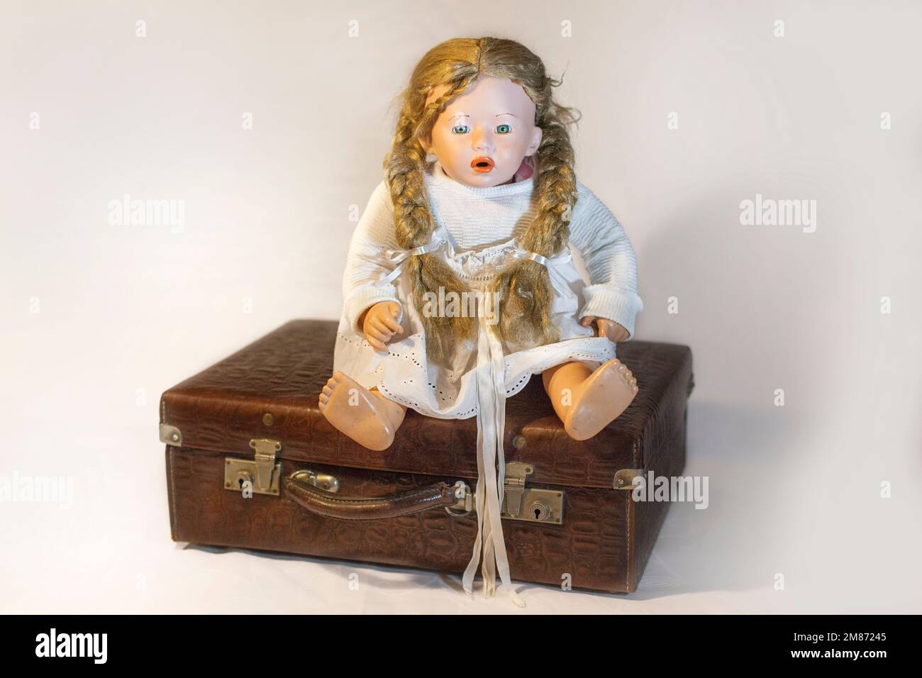 Old antique leather case with a girl puppet Stock Photo - Alamy