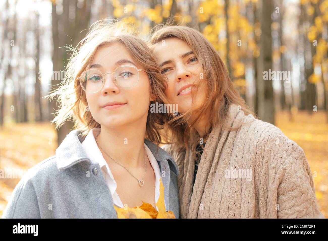 Nice, lovely family of mother and daughter have fun together, embracing ...