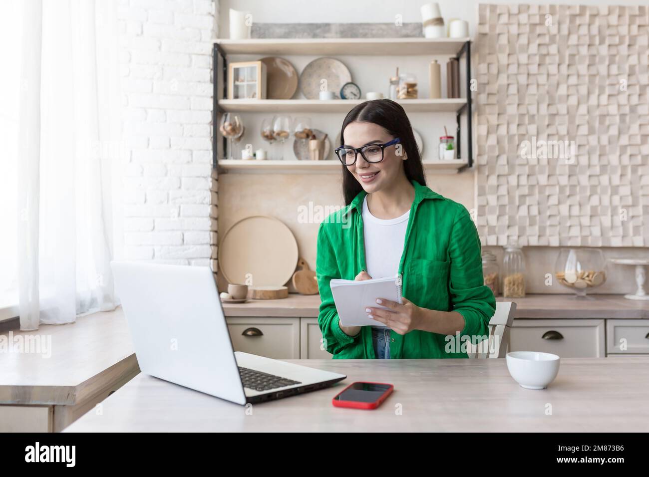 A young beautiful woman is having a remote job interview online ...