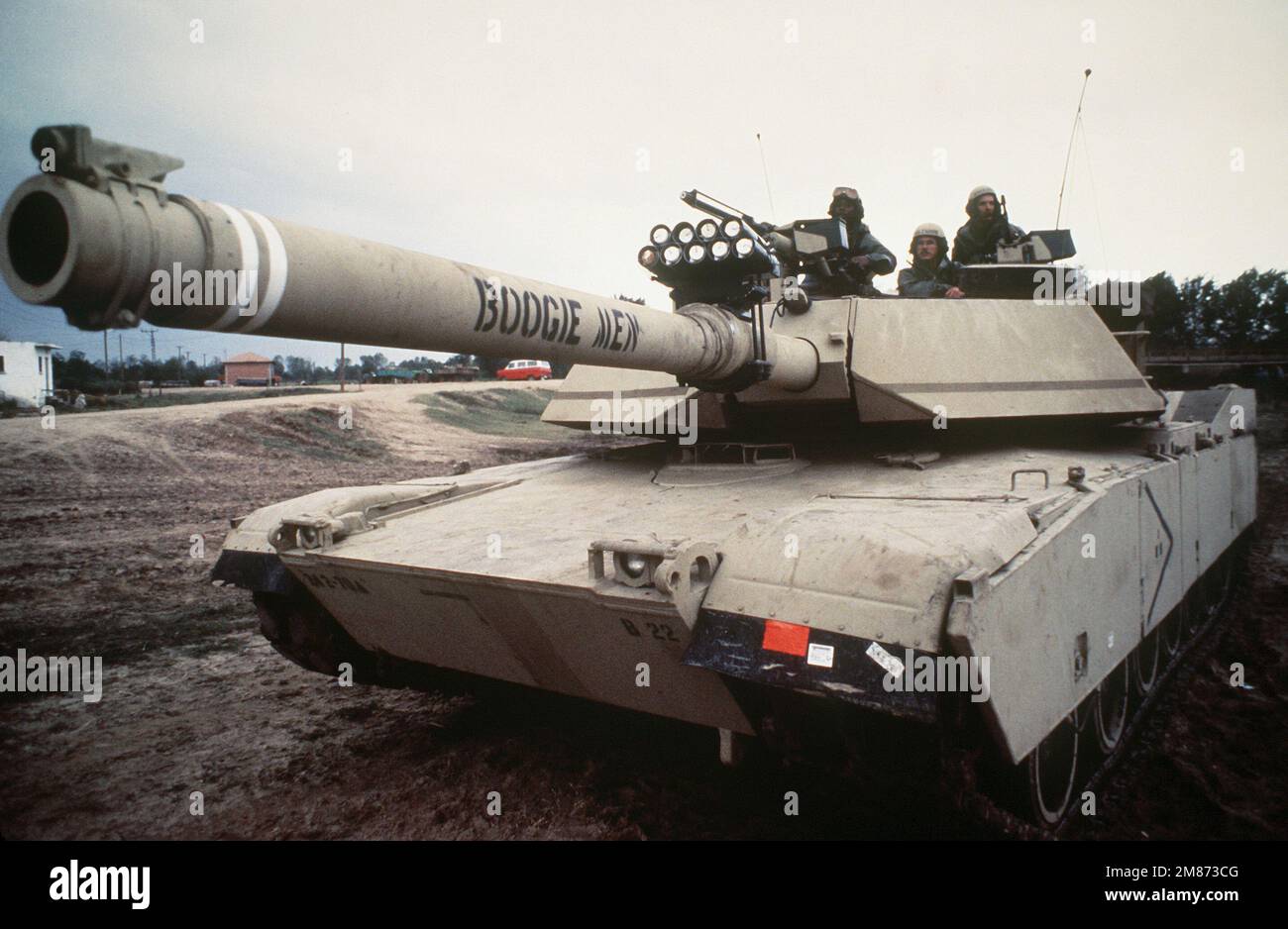 Crewmen stand by in an M-1 Abrams main battle tank from the 24th ...