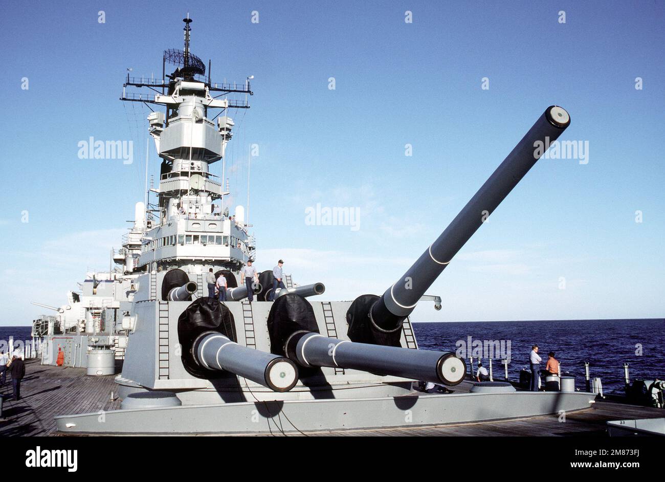Crew members clean the No. 2 Mark 7 16-inch/50-caliber guns aboard the ...