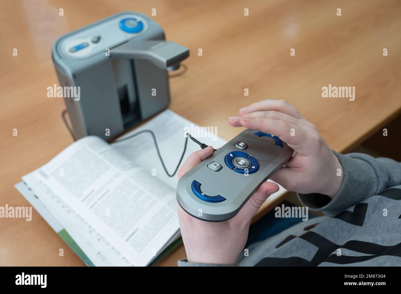 A visually impaired man uses a scanning and reading machine Stock Photo ...