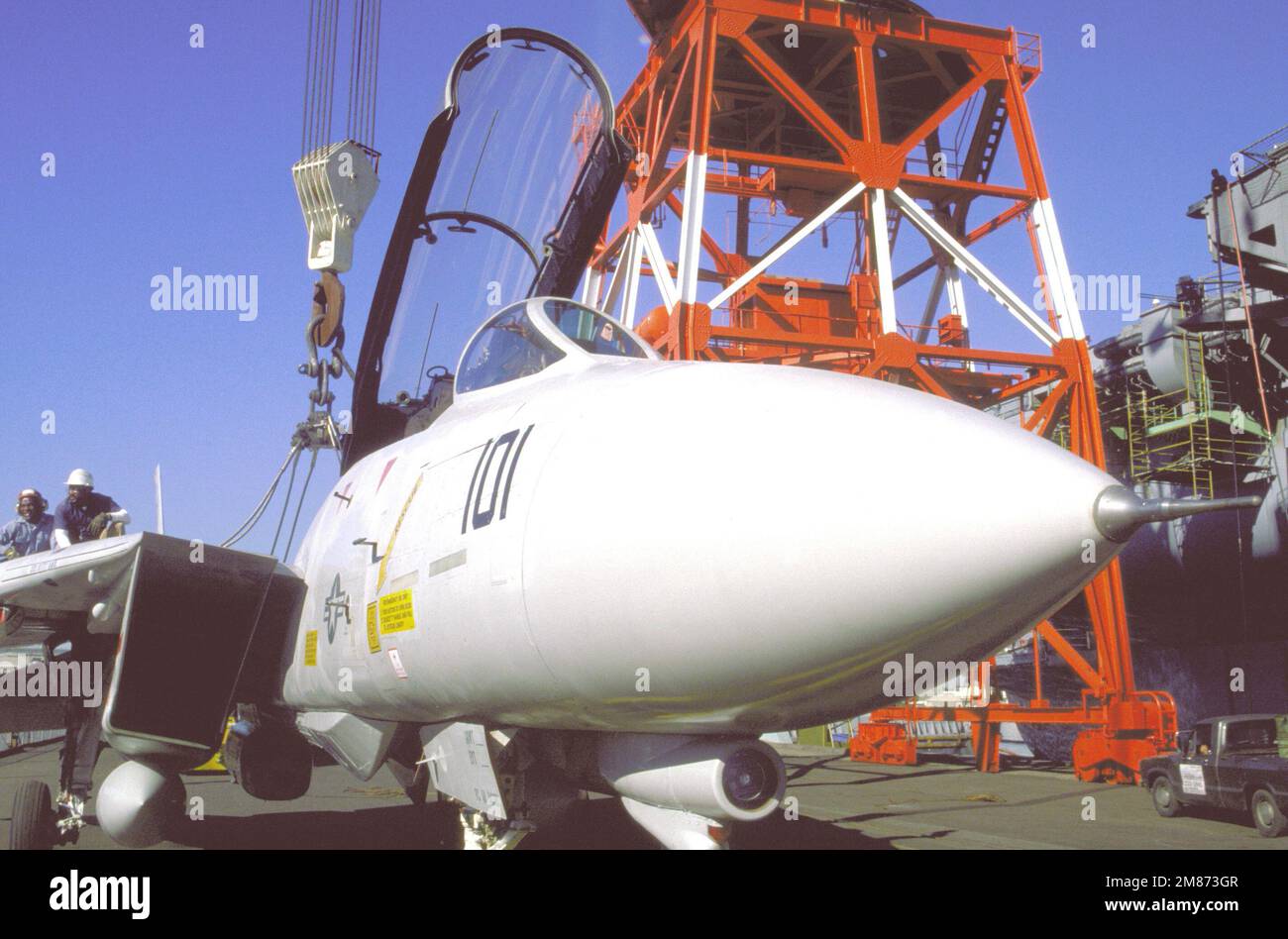 A cable is attached to a Fighter Squadron 211 (VF-211) F-14A Tomcat ...