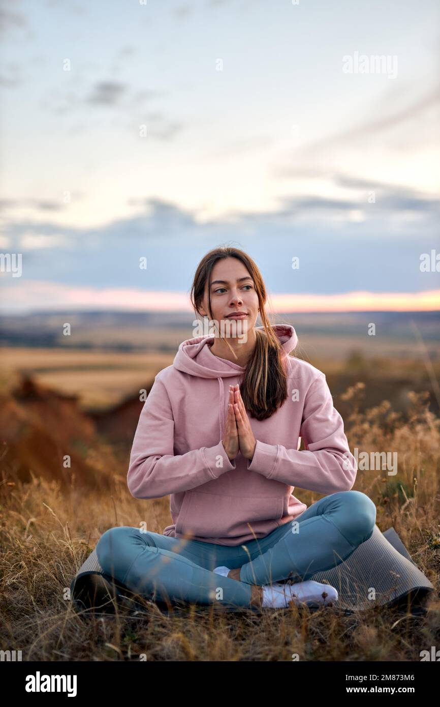 pretty caucasian female keep calm, meditating on fitness mat sitting ...