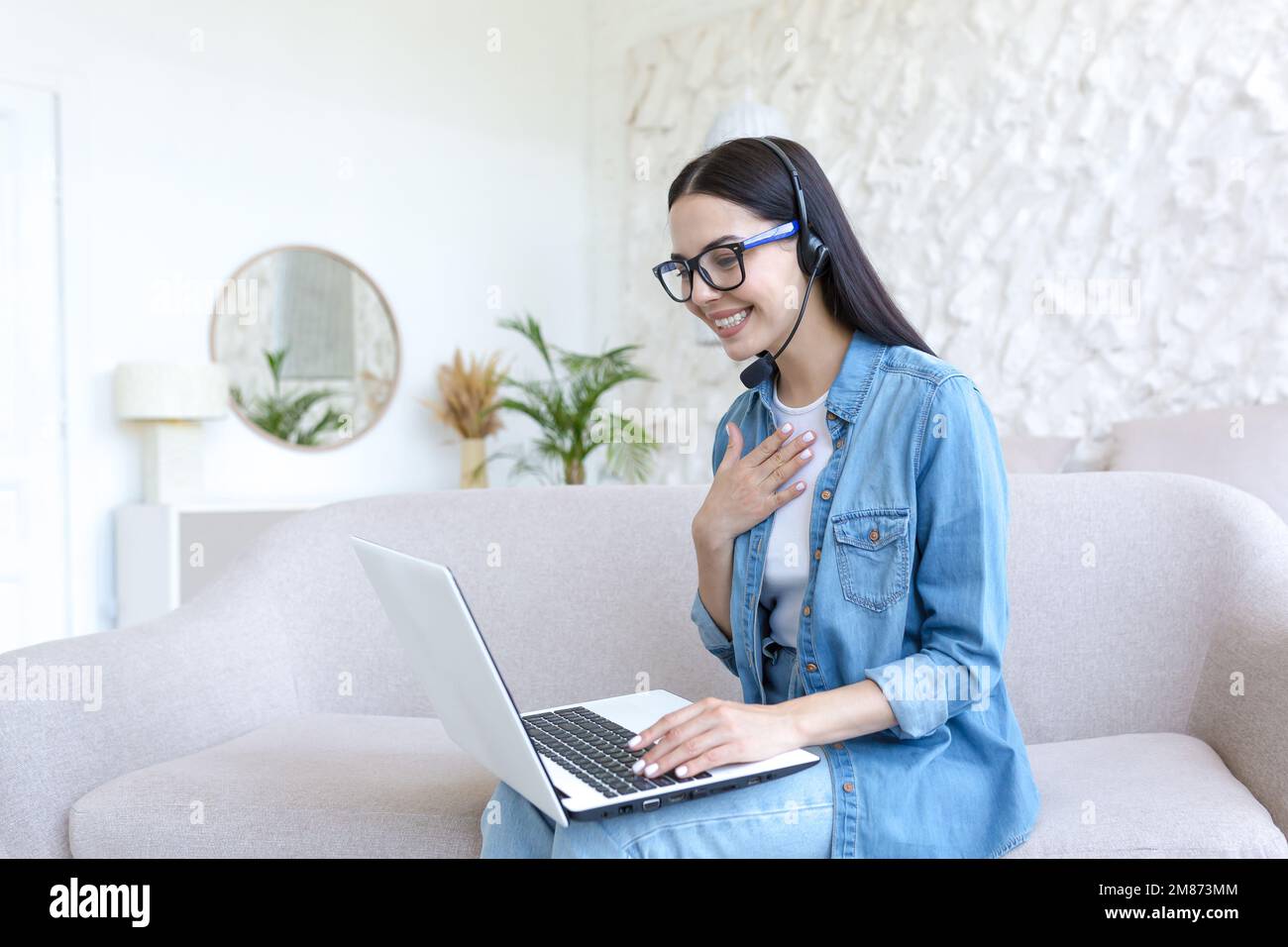 A young beautiful woman is having a remote job interview online ...