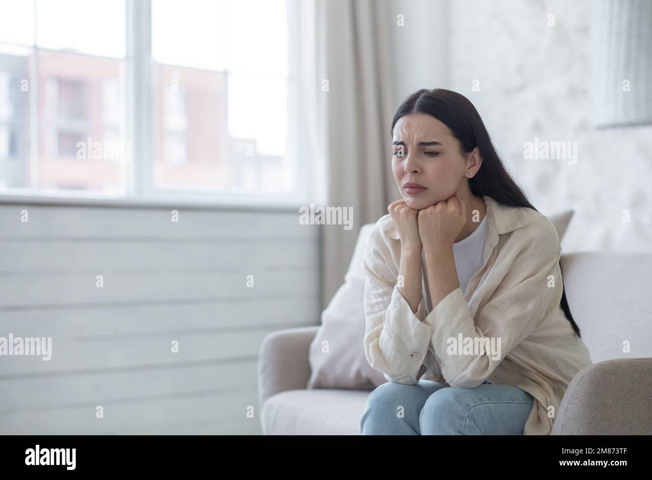 A sad and worried young woman suffers from depression, mental disorders ...
