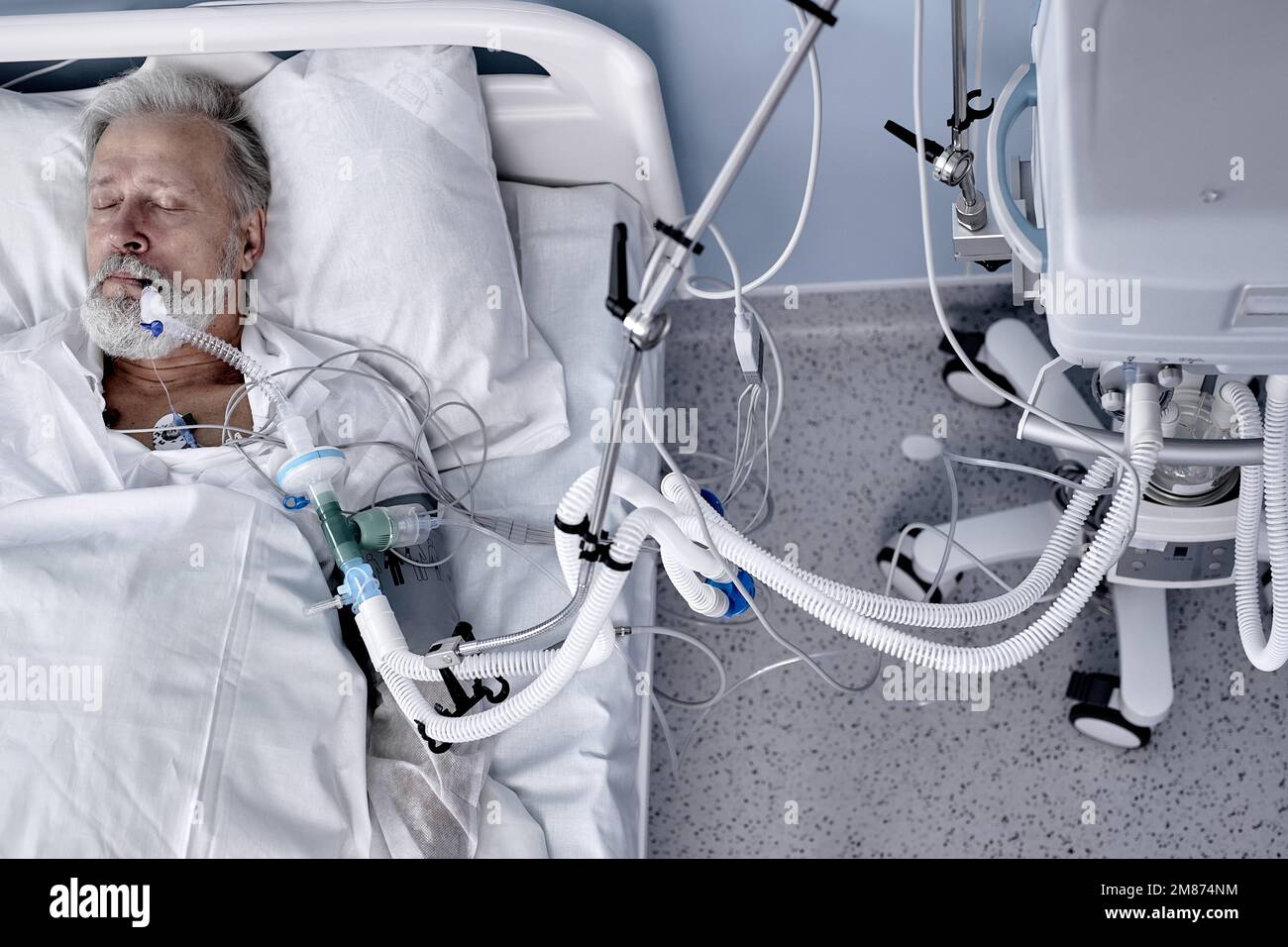 sick caucasian senior patient lies on bed in modern hospital , Saline ...