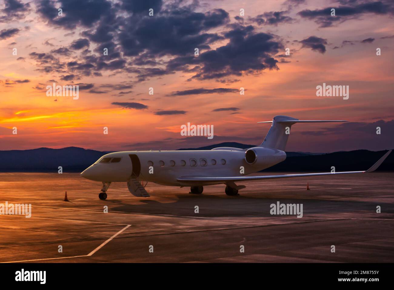 Modern executive aircraft with an opened gangway at the airport apron ...