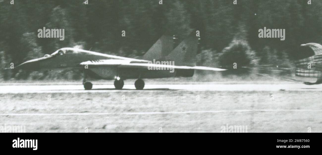 A Soviet MiG-29 Fulcrum aircraft landing with its parachute extended ...