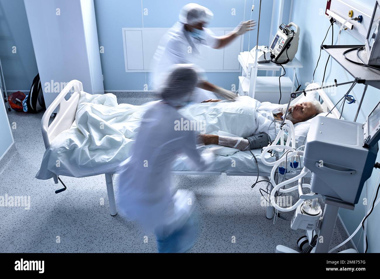 unrecognizable doctors nurses save a patient from death lying on bed in ...