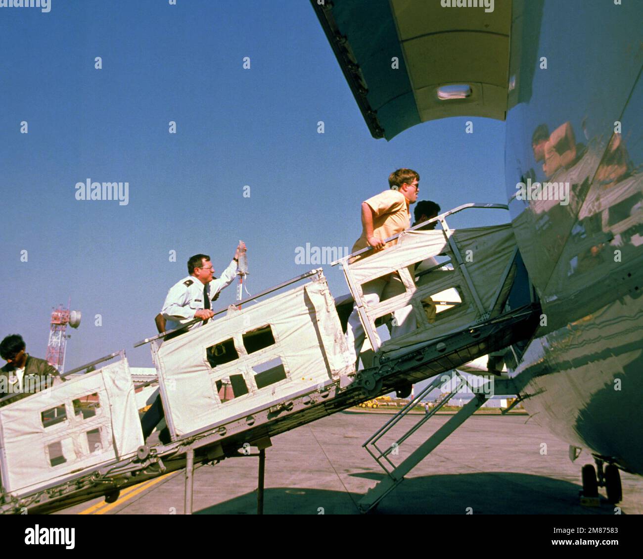 A cardiac arrest patient is rushed aboard a C-9A Nightingale aircraft ...
