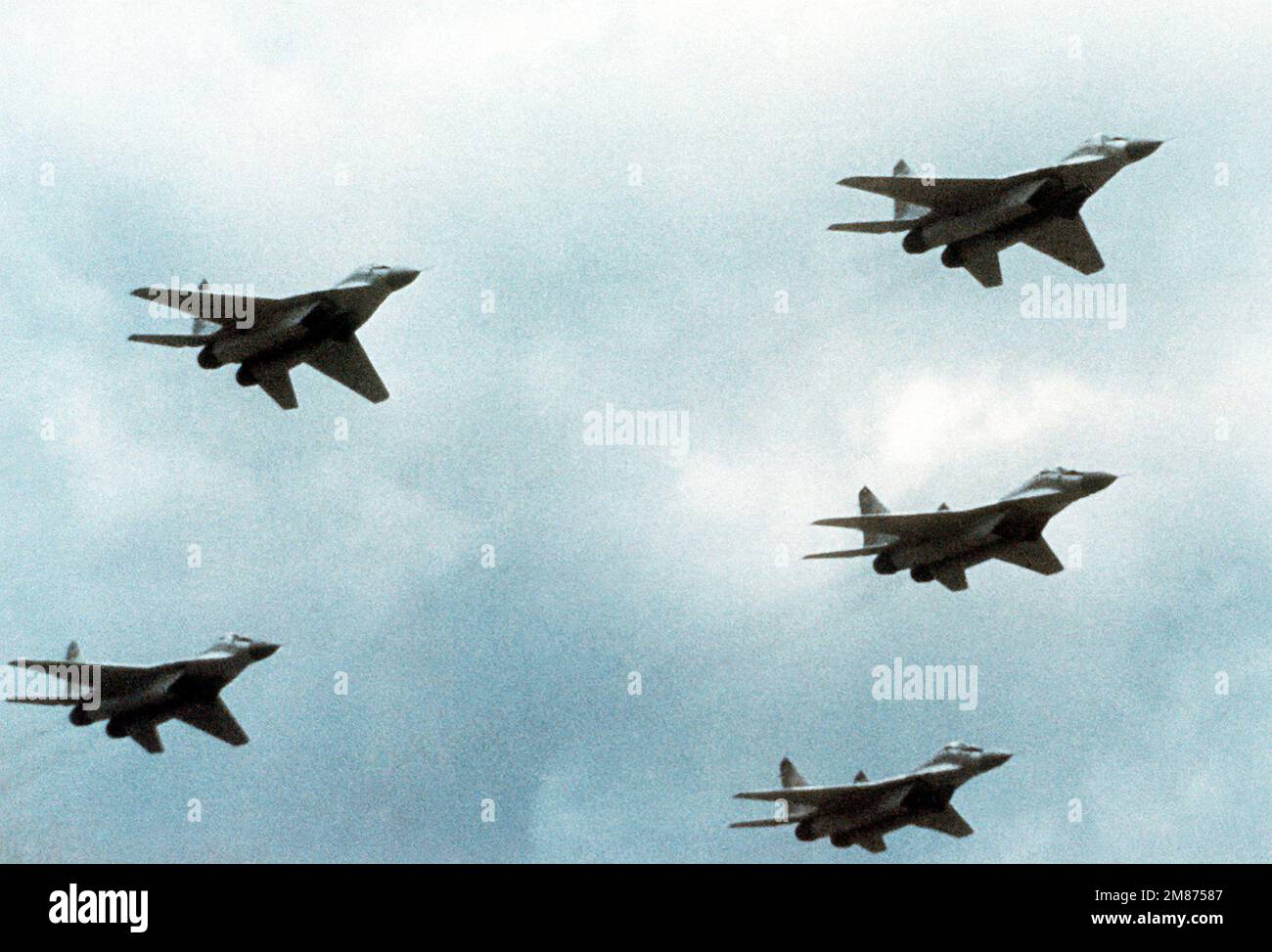 A right underside view of five Soviet MiG-29 Fulcrum aircraft flying in ...