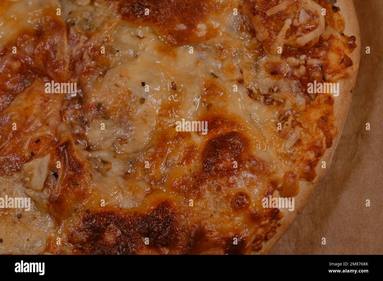 Concept of fatty and unhealthy fast food. Cheese pizza on baking paper ...