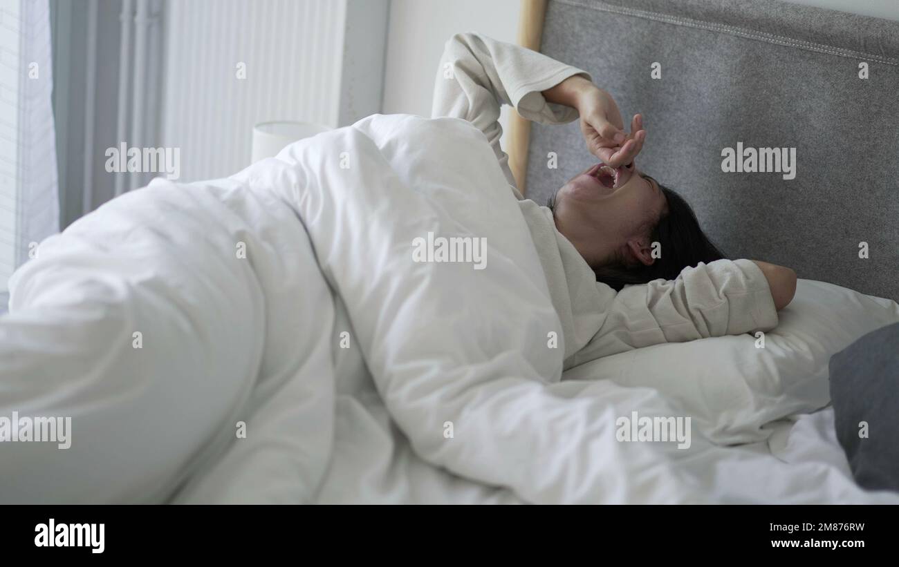 Woman yawning in the morning bed, waking up. Candid real life yawn ...