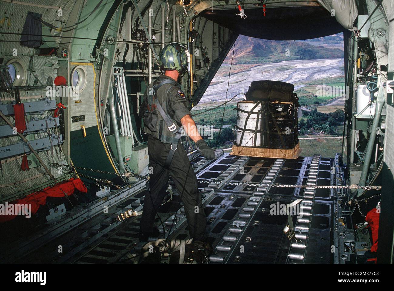 TSGT Gambert of the 345th Tactical Airlift Squadron, holds onto a ...