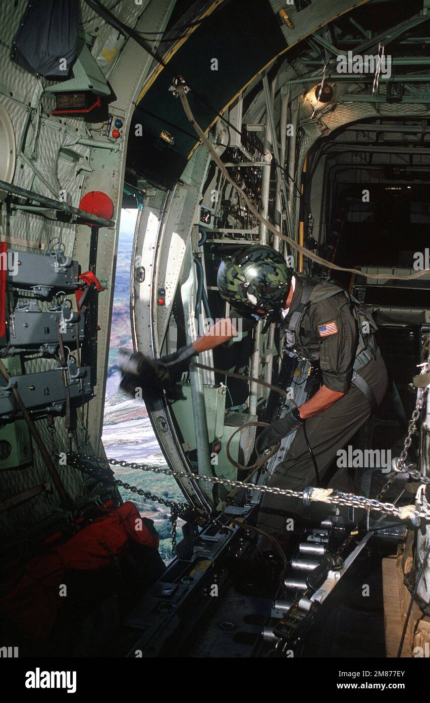 TSGT Gambert of the 345th Tactical Airlift Squadron drops cargo from a ...