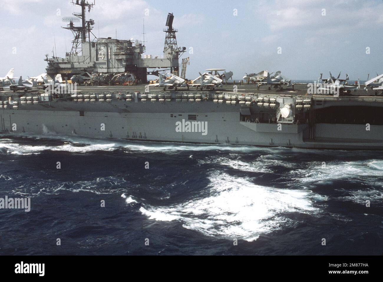 Various aircraft are parked on the flight deck of the aircraft carrier ...