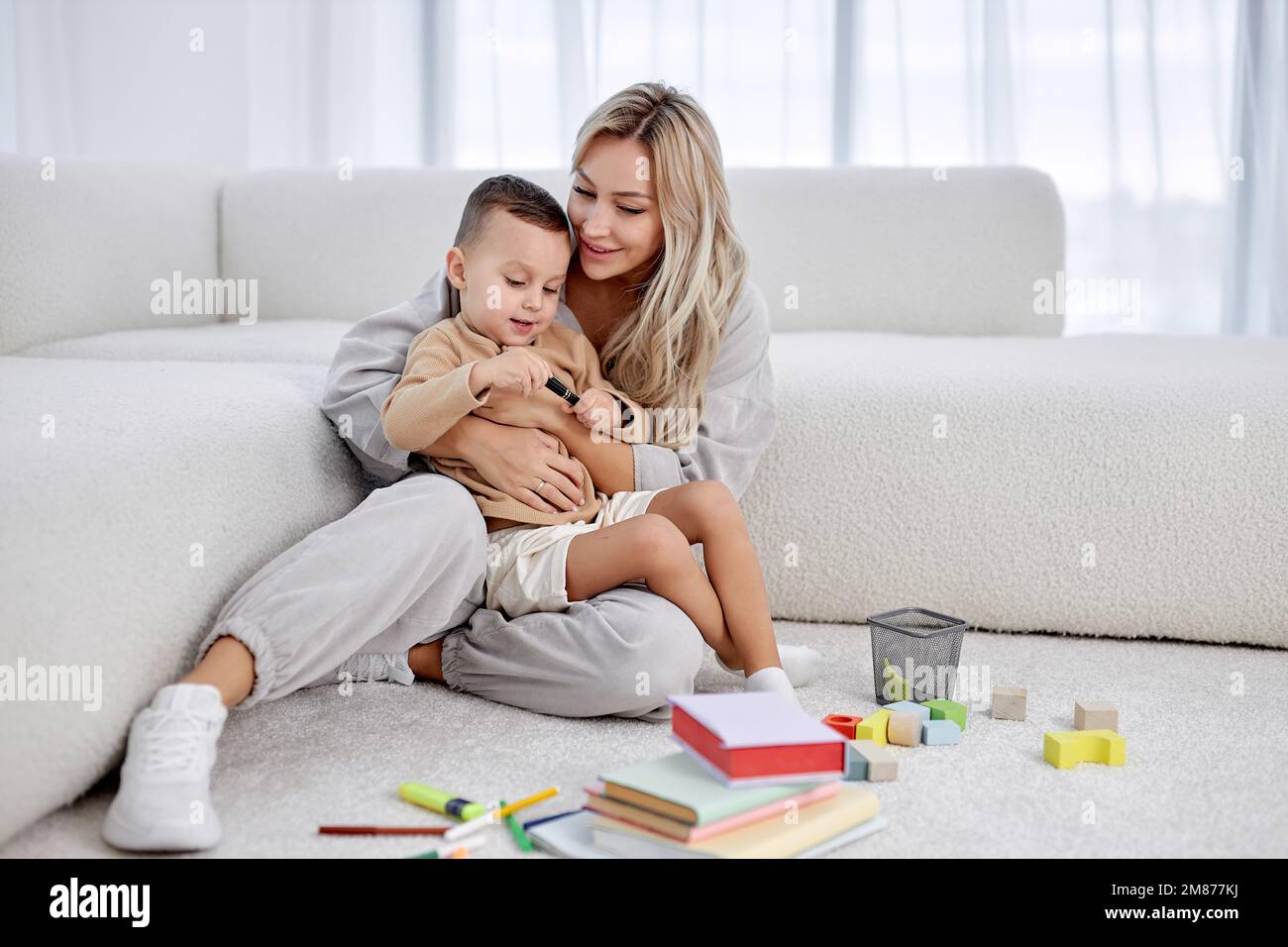 mother has a good time with son of preschool age, laughing. Carefree ...