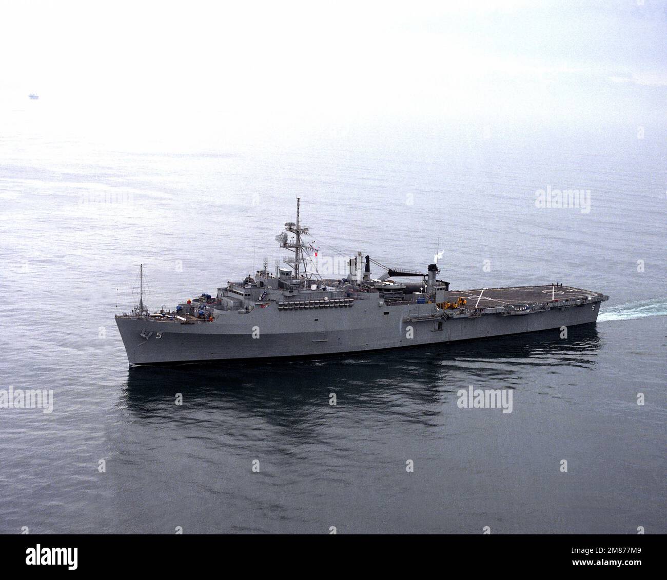 A port view of the amphibious transport dock USS OGDEN (LPD 5) underway ...