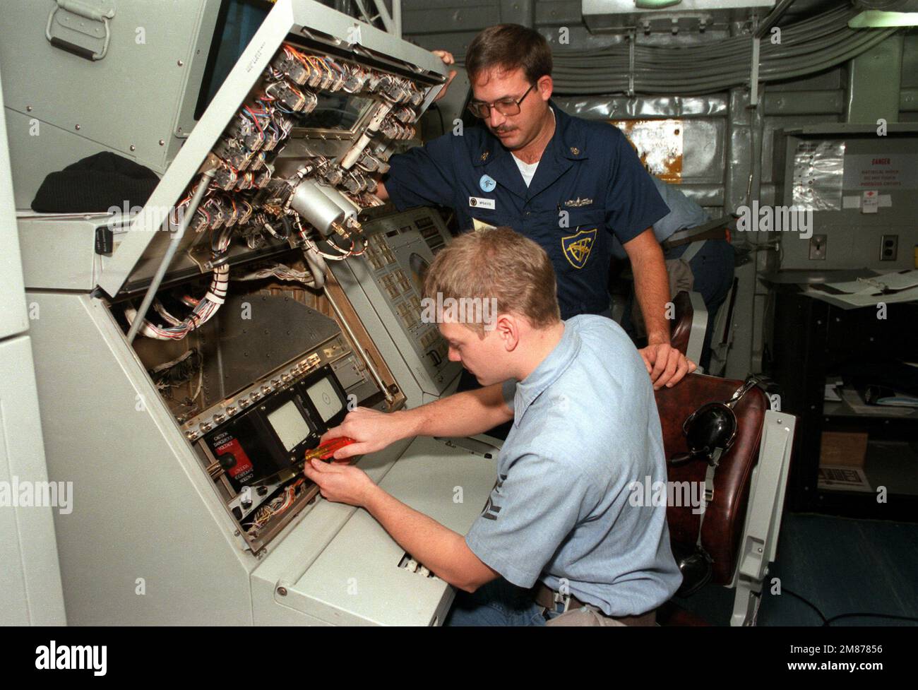 A member of the Fleet Training Group observes as a fire control ...