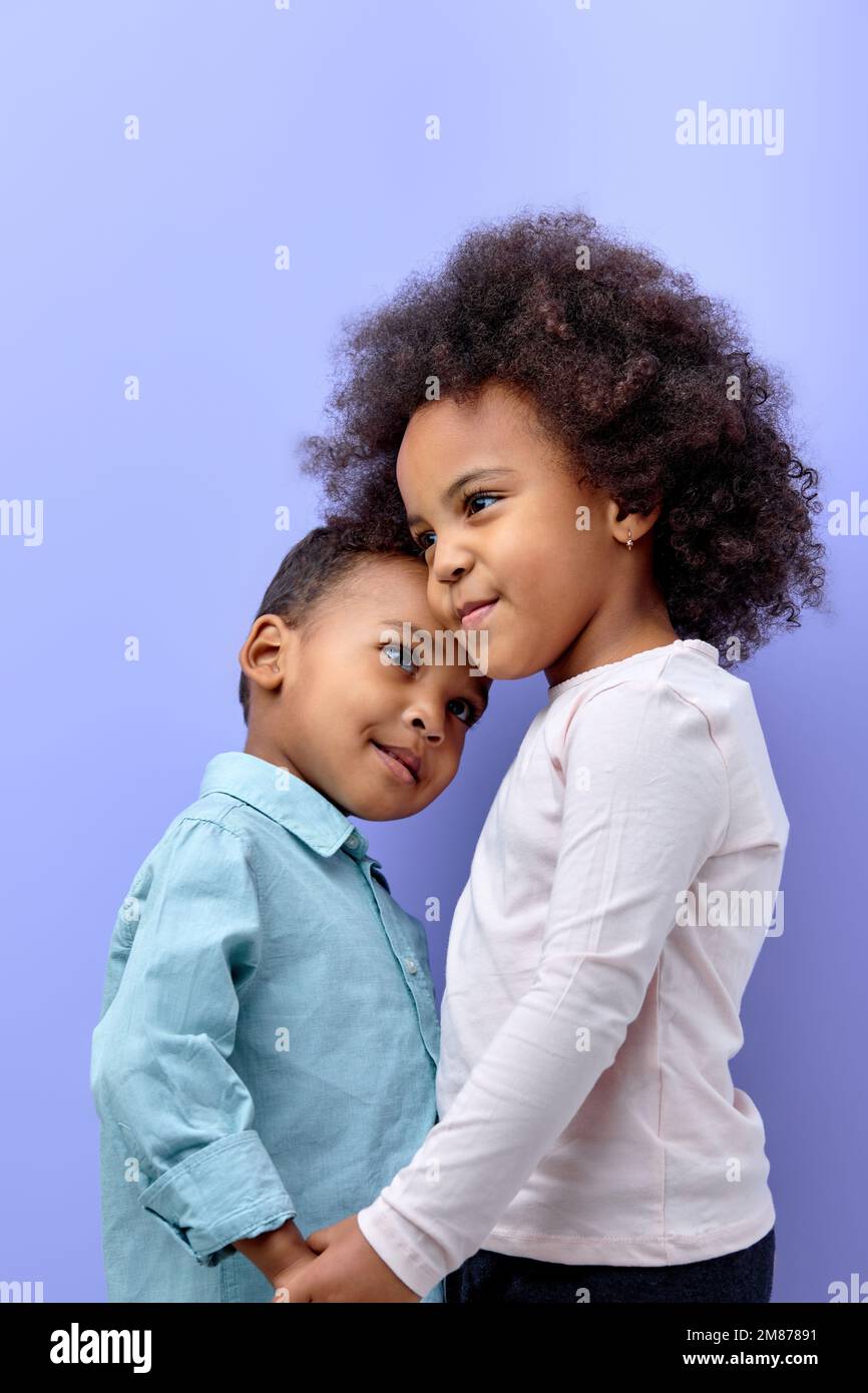 two pretty kid friends hugging holding hands together isolated over ...