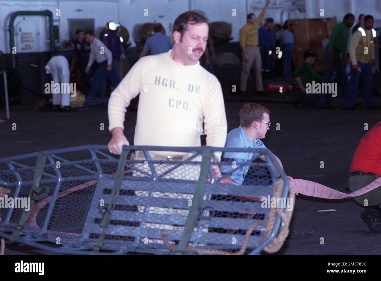 An instructor carries a Stokes litter to transport simulated casualties ...