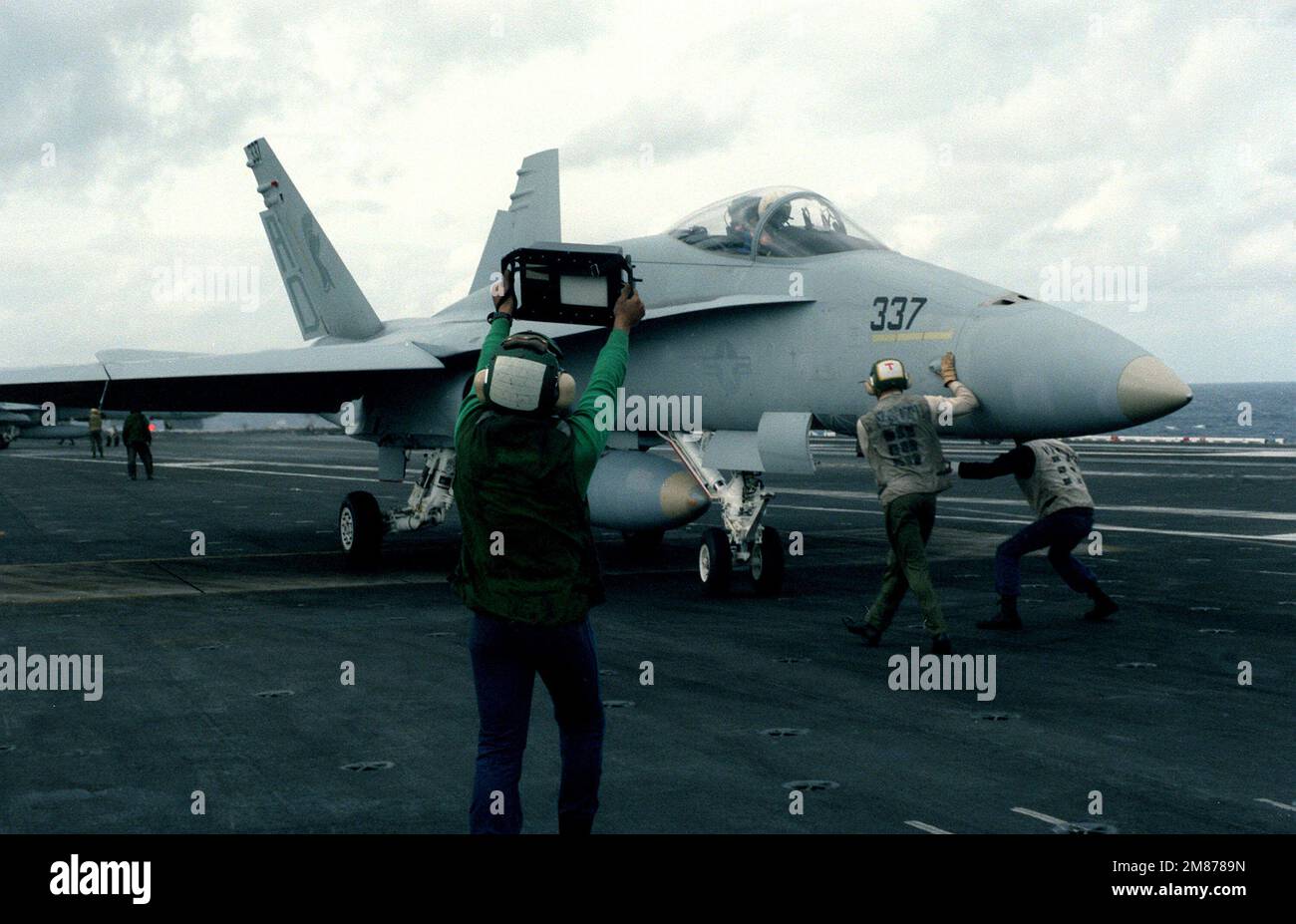 An aircraft handler aboard the nuclear-powered aircraft carrier USS ...