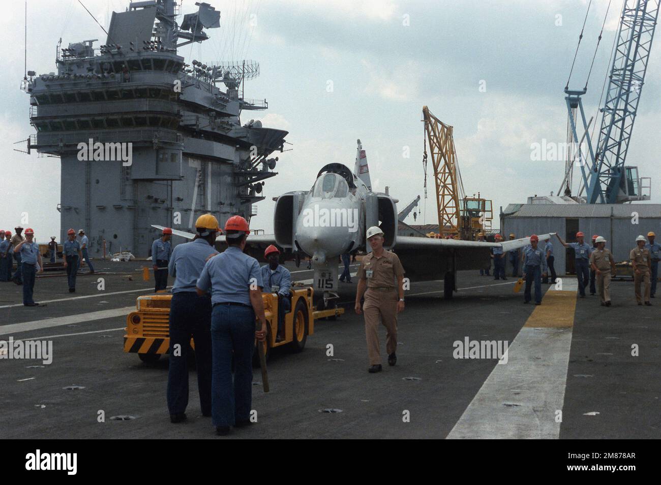 An MD -3A tow tractor is used to move an F-4 Phantom II aircraft on the ...