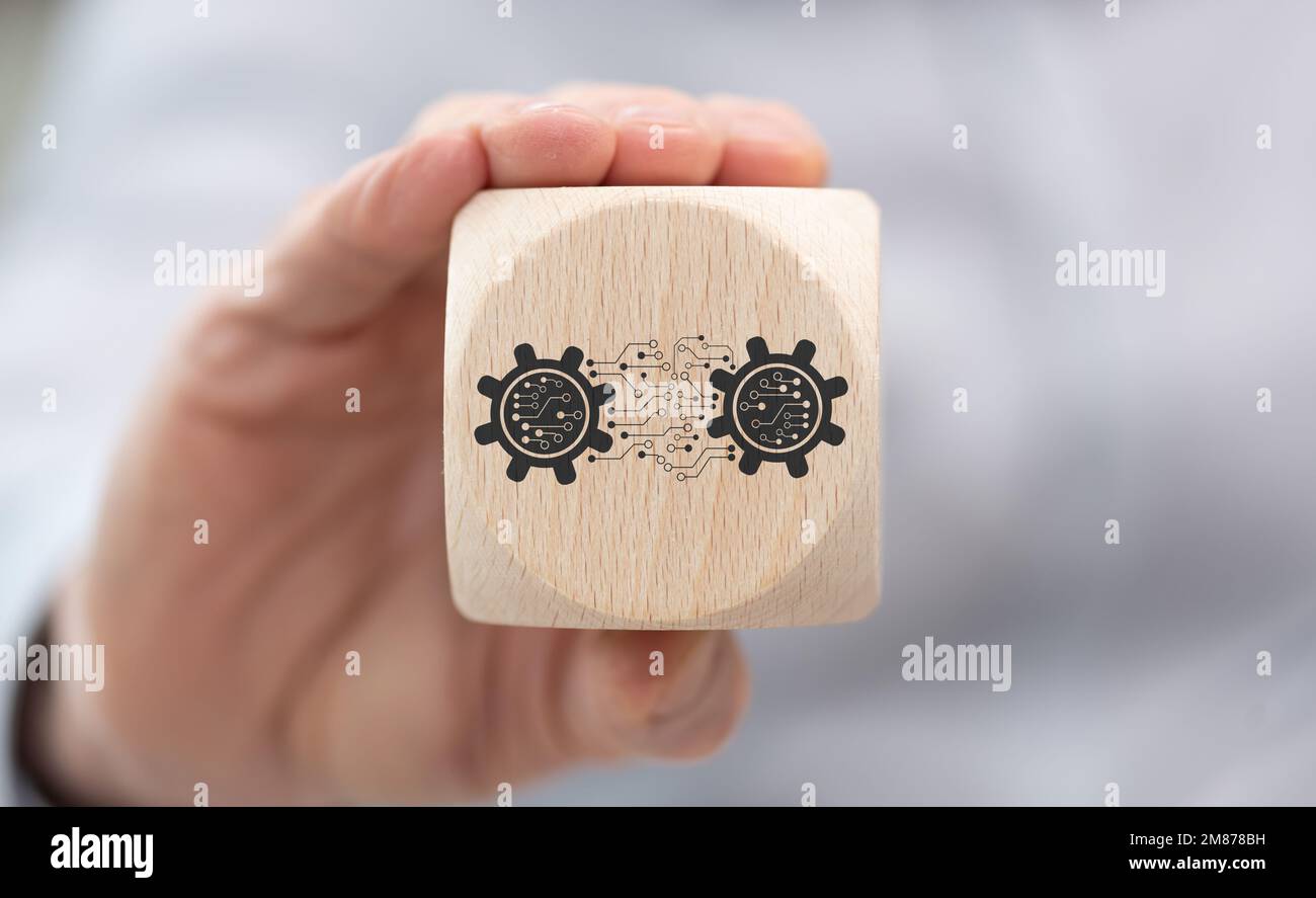 Hand holding a wooden cube with symbol of automation concept Stock ...