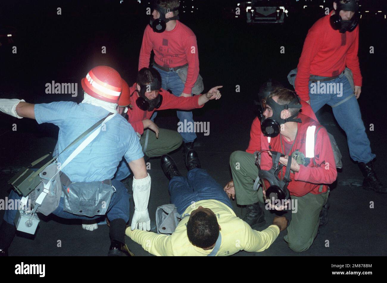 Repair locker personnel wearing Mark 5 protective masks assist a ...