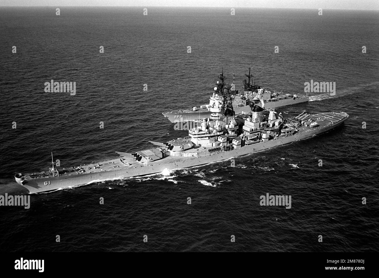 An aerial port bow view of the destroyer USS DEYO (DD-989) and the battleship USS IOWA (BB-61 ...