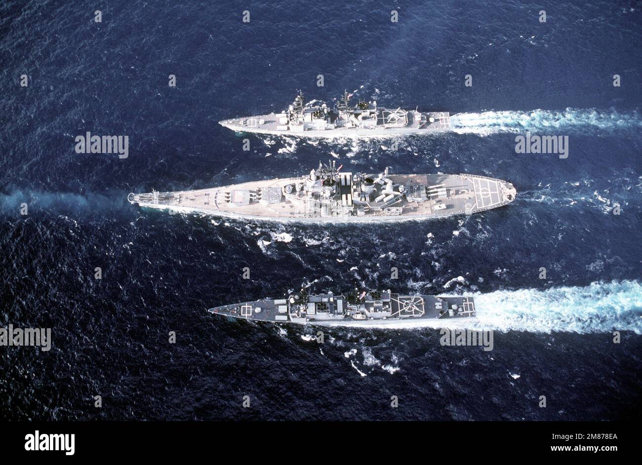 An aerial port quarter view of the destroyer USS DEYO (DD-989), top, the battleship USS IOWA (BB ...