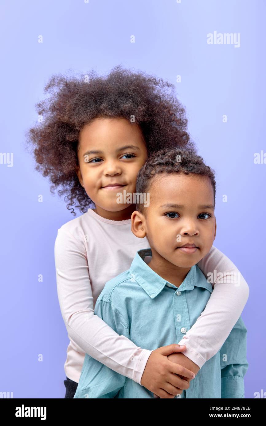 Cute black girl hugging little brother, showing love and affection ...