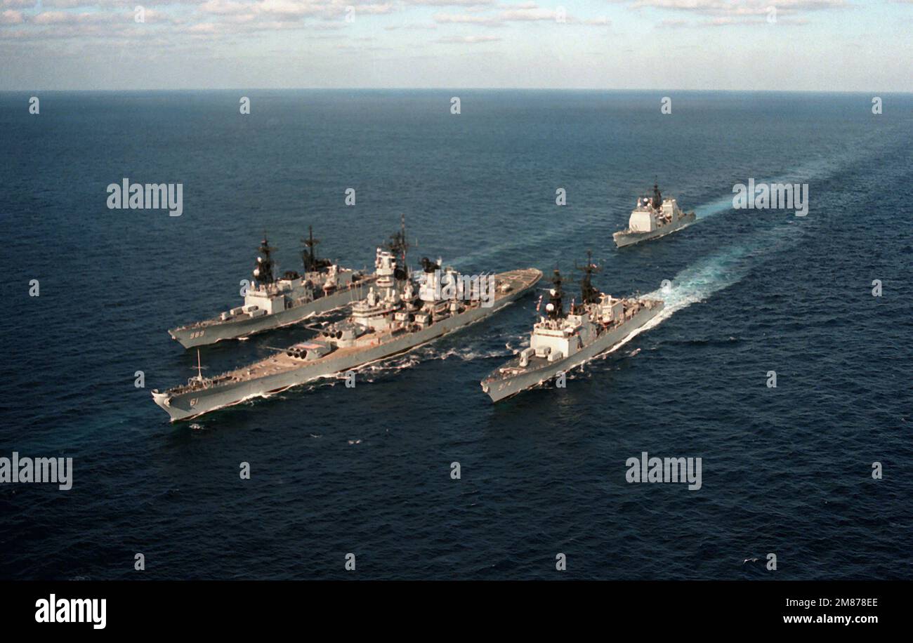 An aerial port bow view of U.S. Navy ships underway in formation. They are, left to right ...