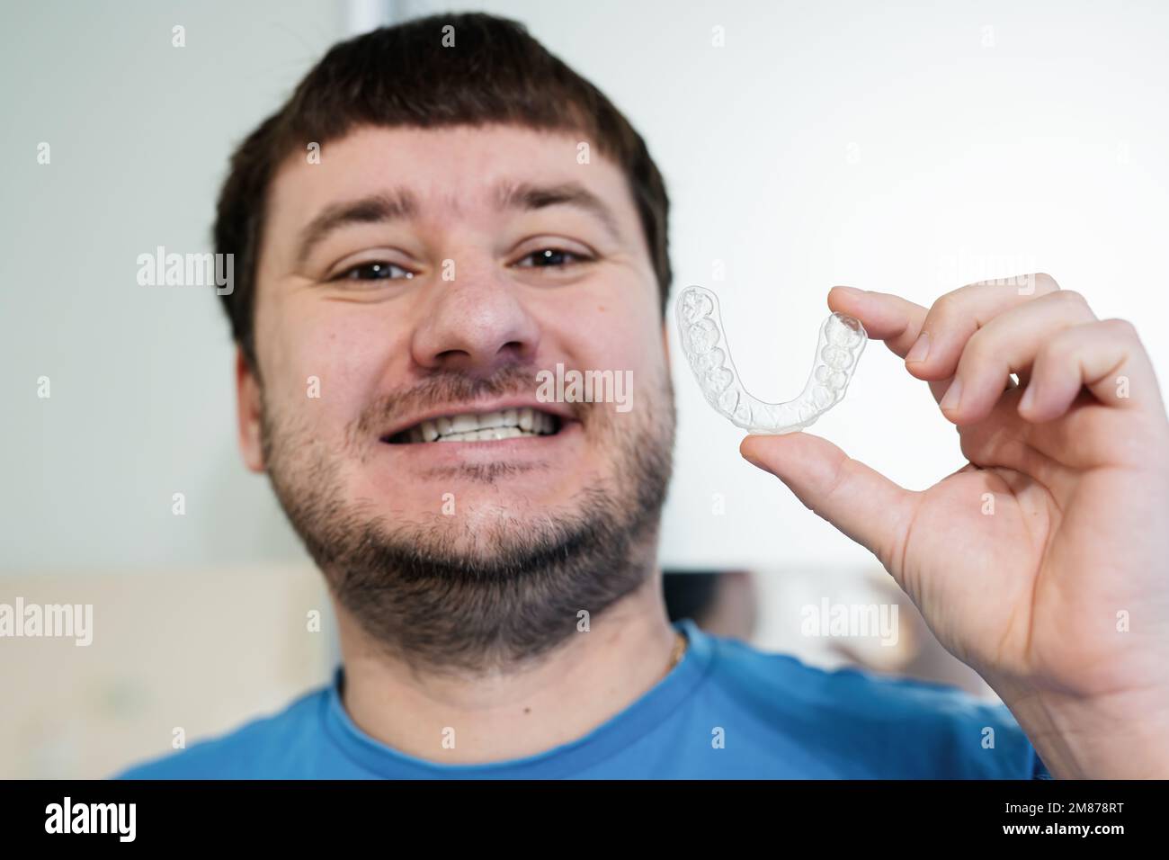 Mobile orthodontic appliance for dental correction. Man wearing ...