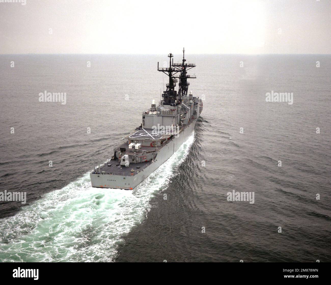 A starboard quarter view of the destroyer USS CARON (DD-970) underway ...
