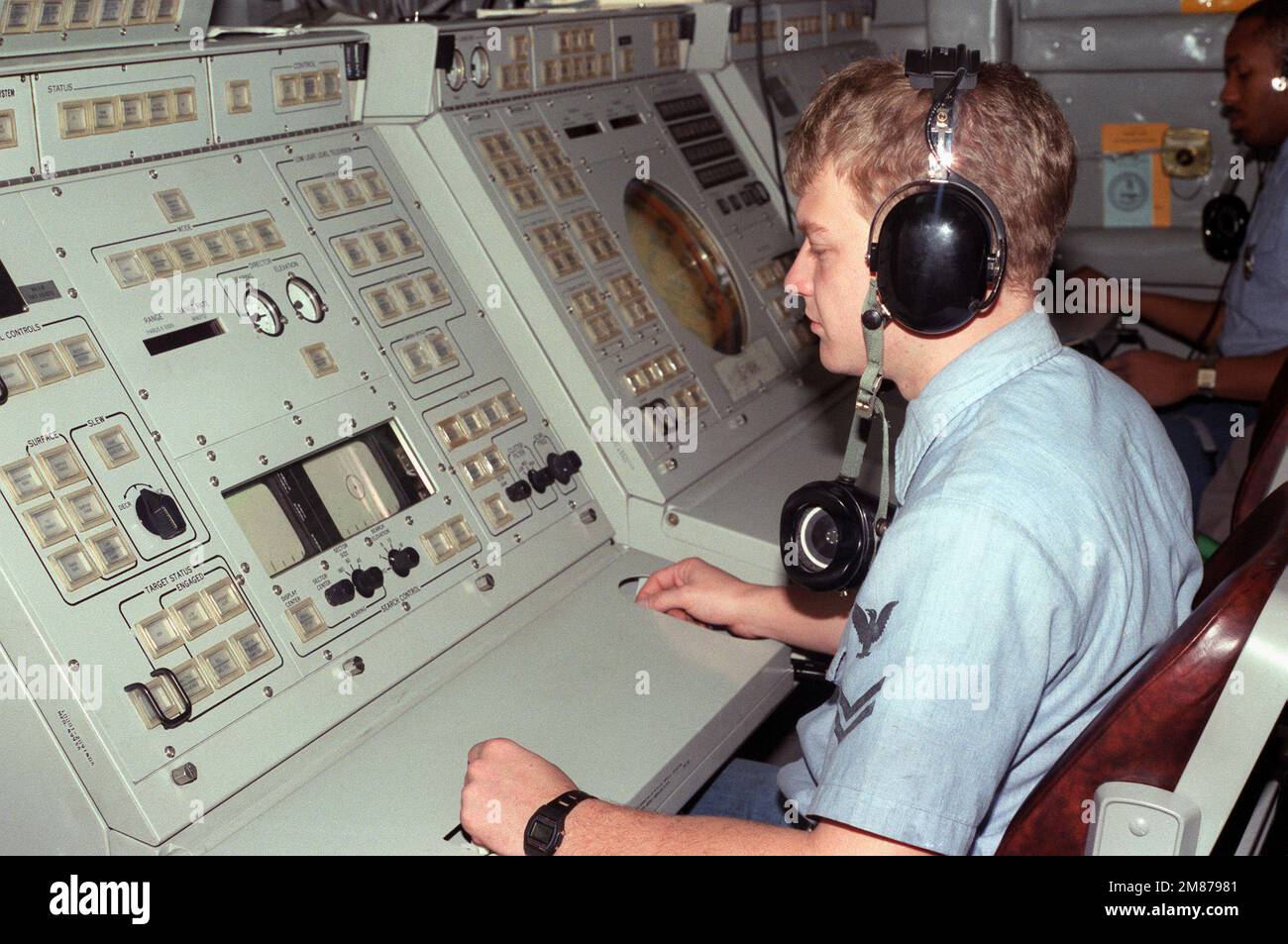 A fire control technician mans a targeting information console aboard ...