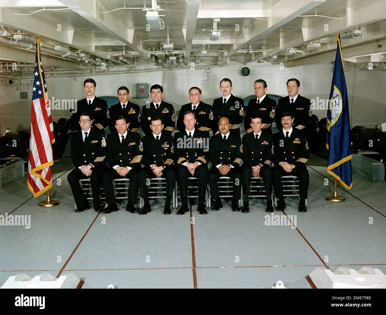Captain Paul W. Parcells, seated center, Commanding Officer of the ...