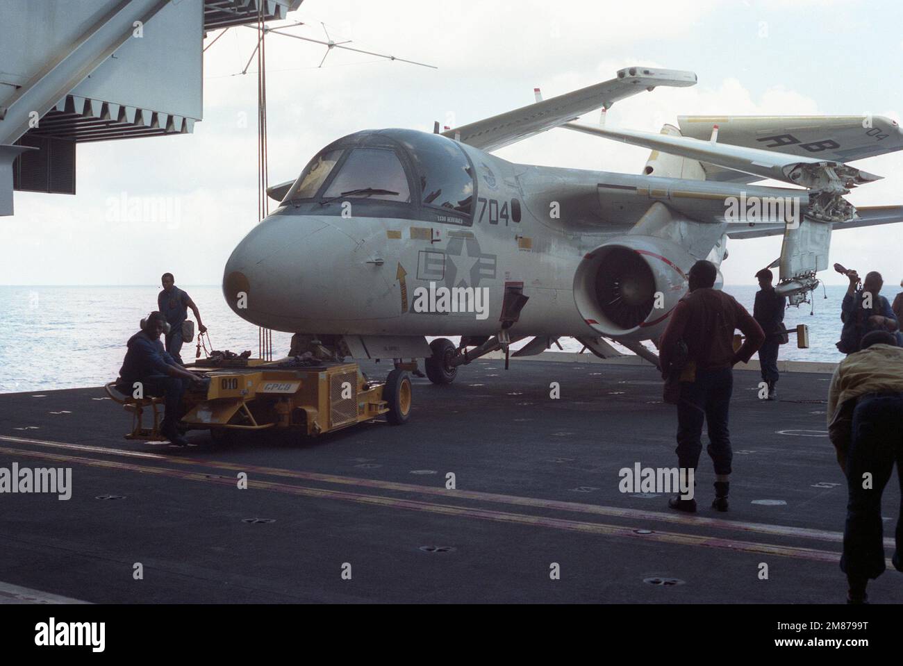 Aircraft handlers prepare to move an S-3A Viking aircraft from an ...